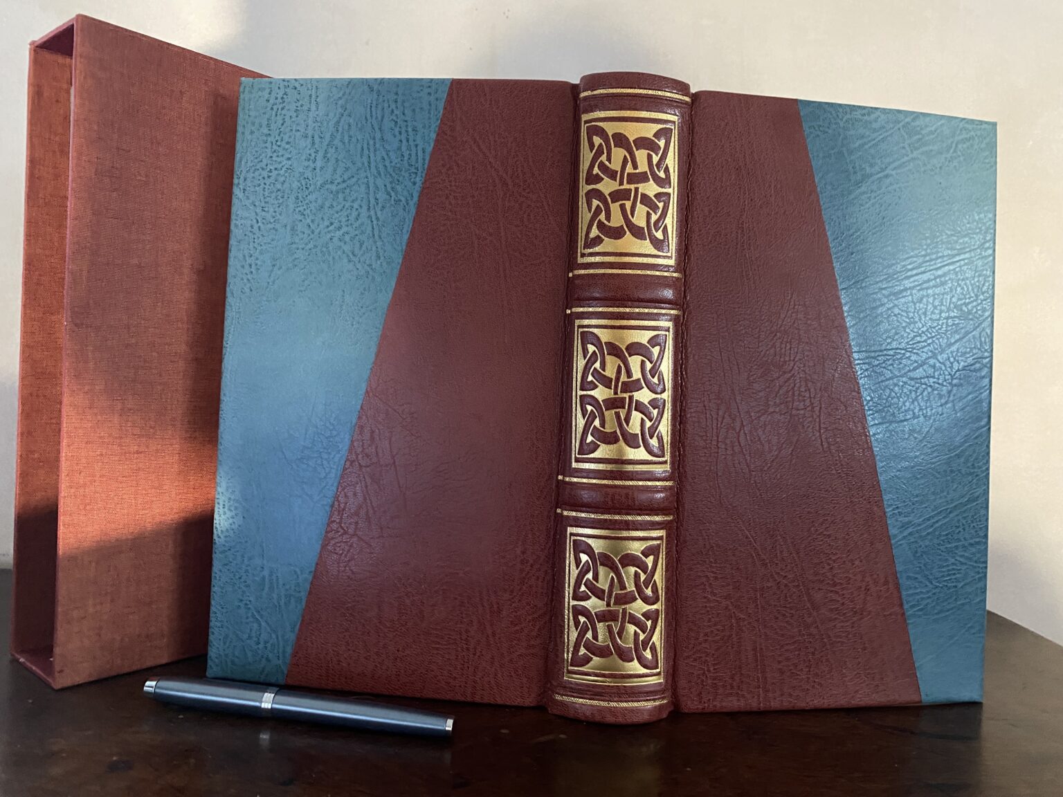 Large, Chunky plain paged book bound in terracotta and pale blue ...