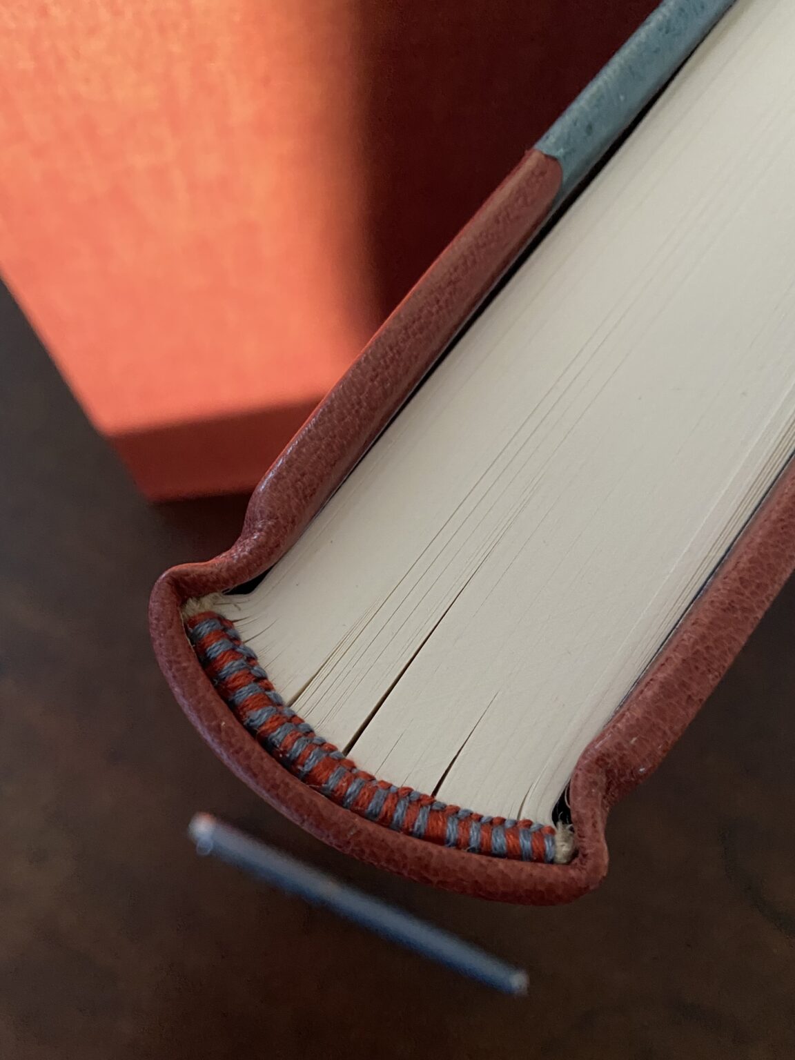 Large, Chunky plain paged book bound in terracotta and pale blue ...