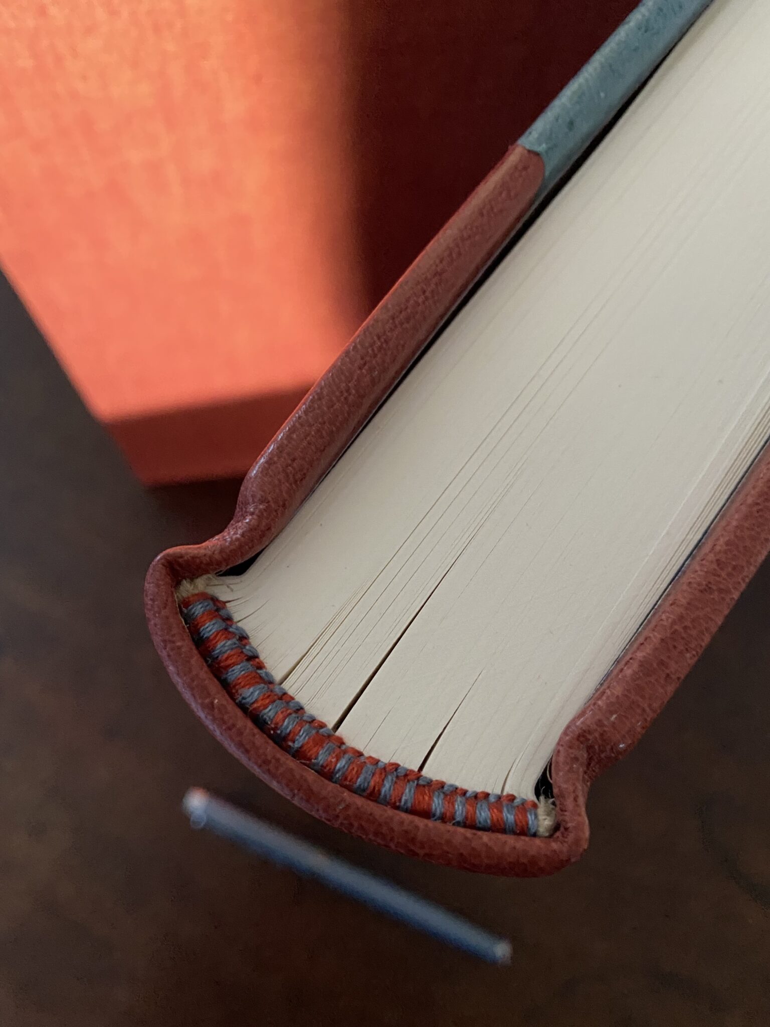 Large, Chunky plain paged book bound in terracotta and pale blue ...